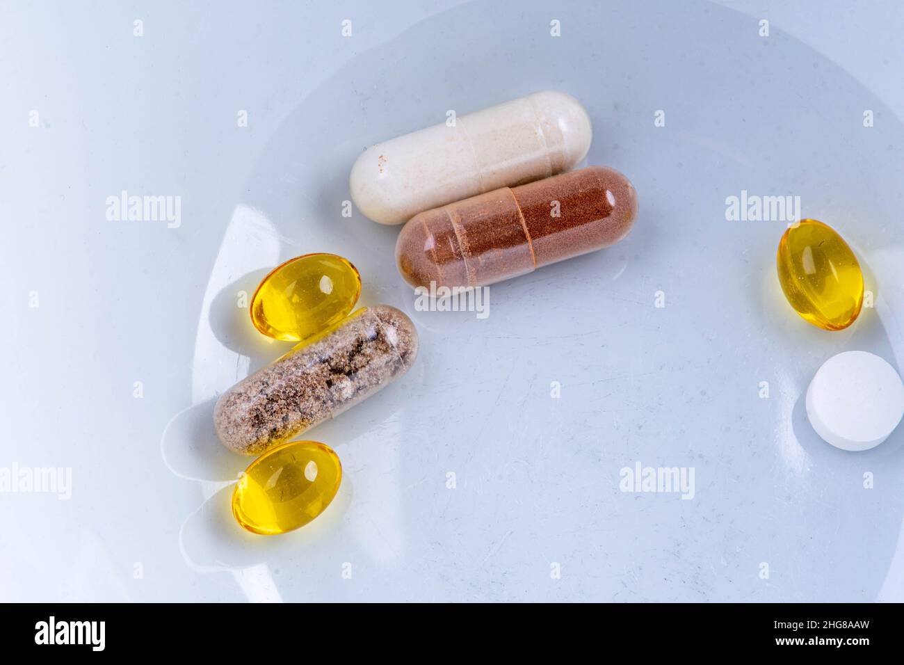 Empty bowl with vitamins and tablets Stock Photo - Alamy