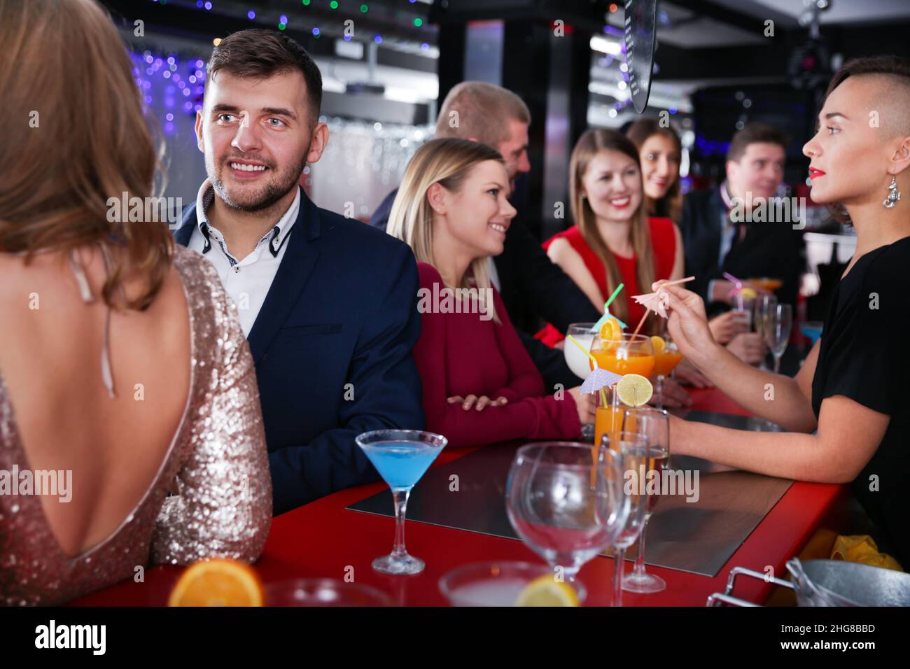 Friendly colleagues partying in bar and toasting drinks Stock Photo - Alamy