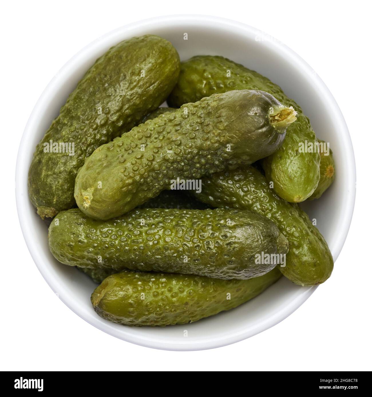 Bowl of Tasty canned Whole green cornichons isolated on a white ...