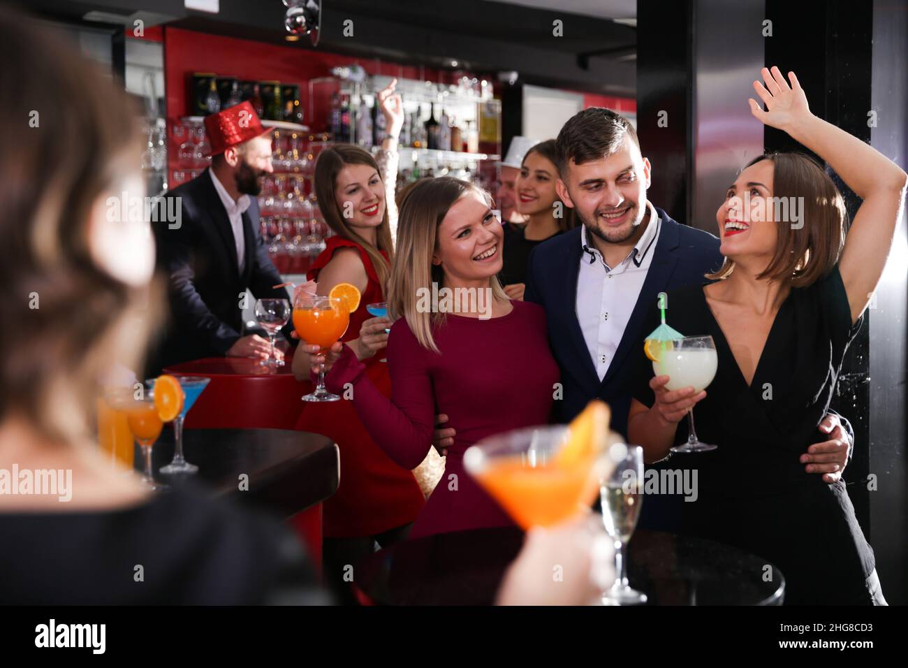 Guy with two girls partying in bar Stock Photo - Alamy