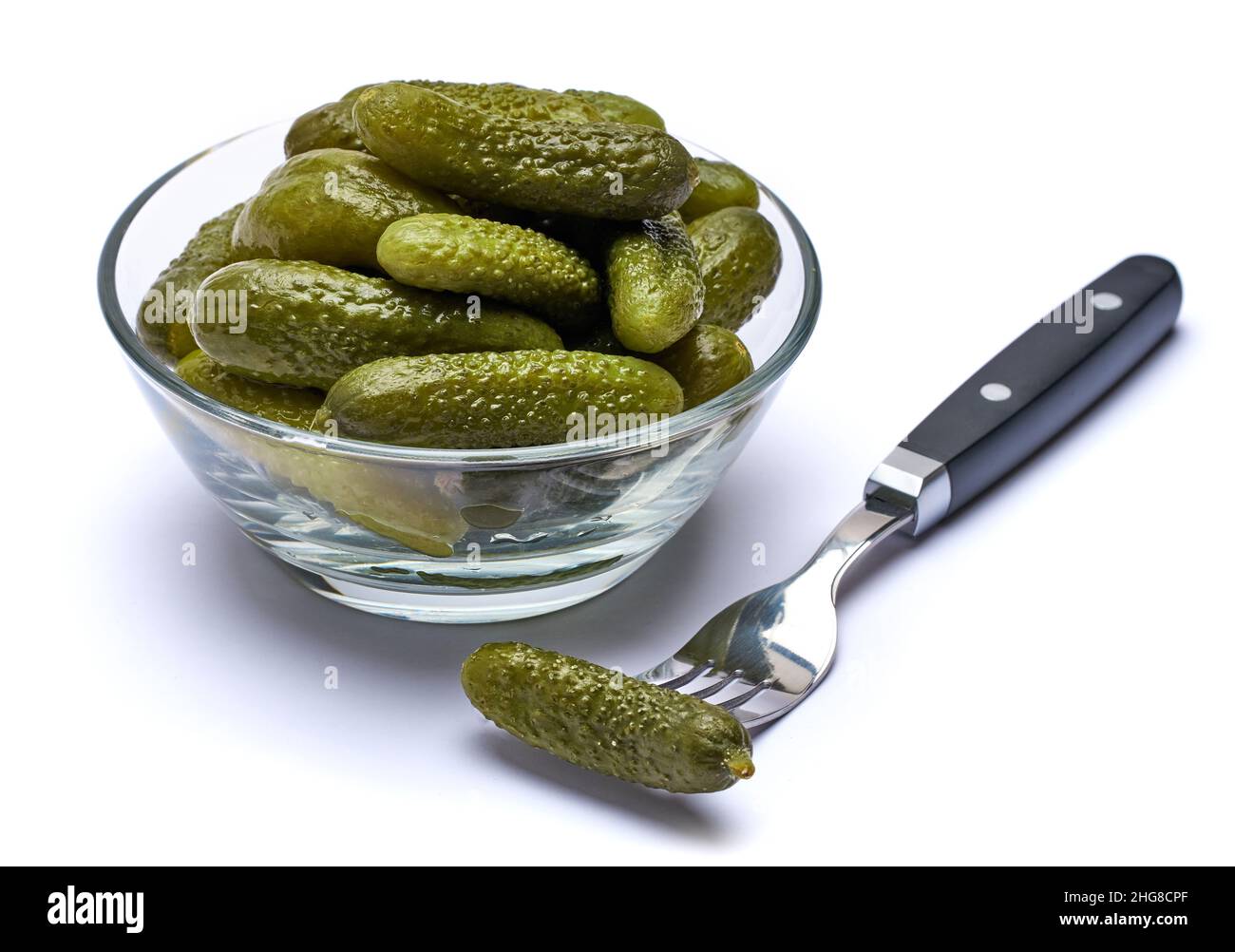 Bowl of Tasty canned Whole green cornichons isolated on a white ...