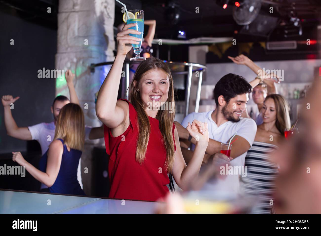 Woman dancing in the night club with drinks Stock Photo - Alamy