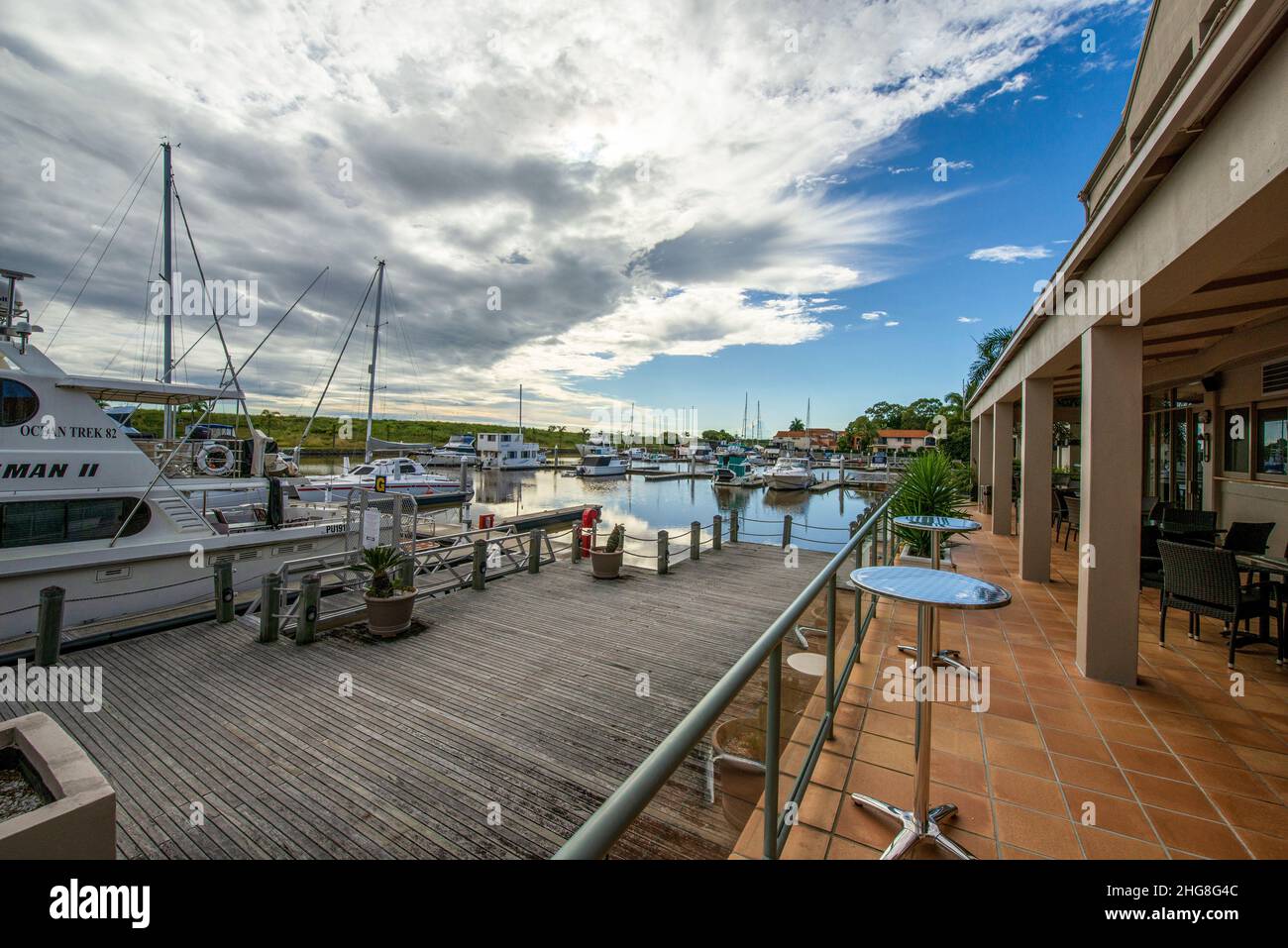 Dramatic sky over yachts moored at Raffles Marina, Singapore, capturing ...