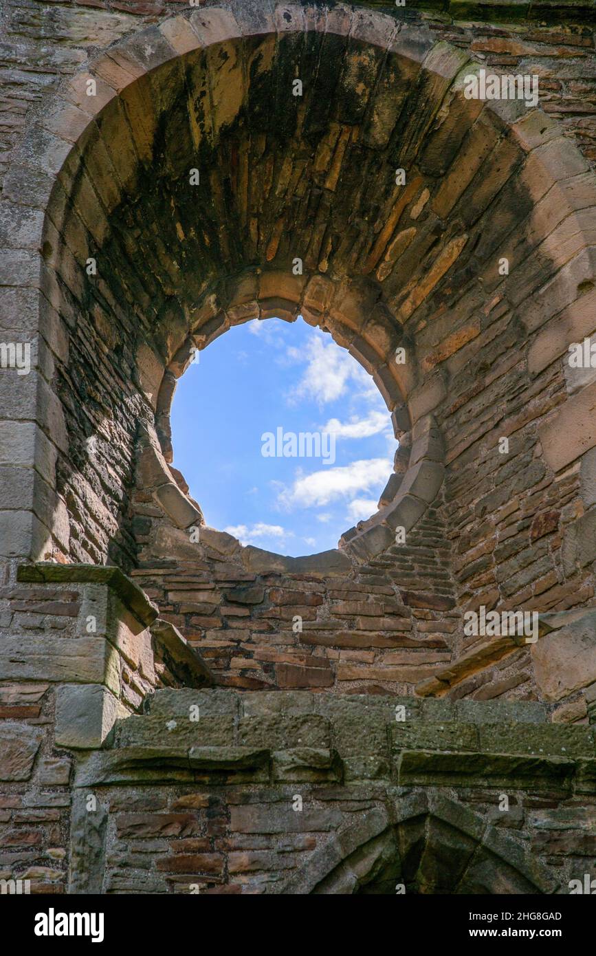 Ancient castle ruins framed by a beautiful blue cloudy sky visible ...