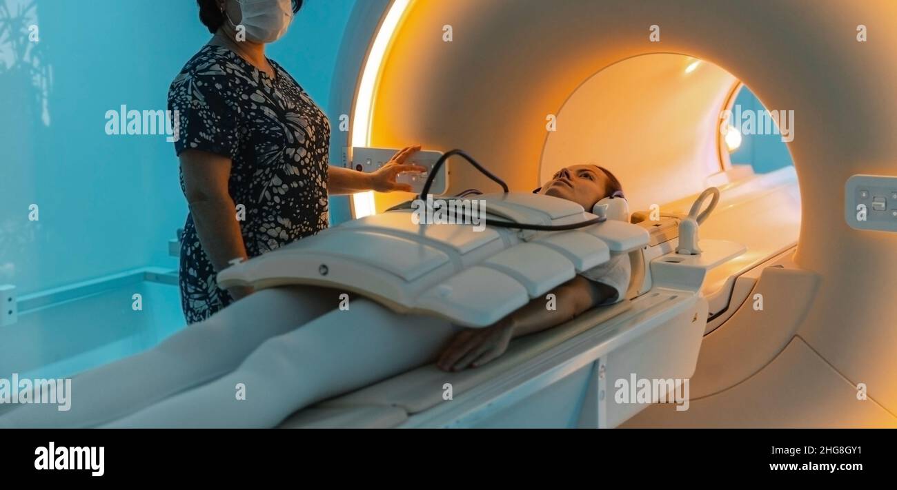 Doctor or nurse and patient with tomography CT or MRI Scan in hospital ...