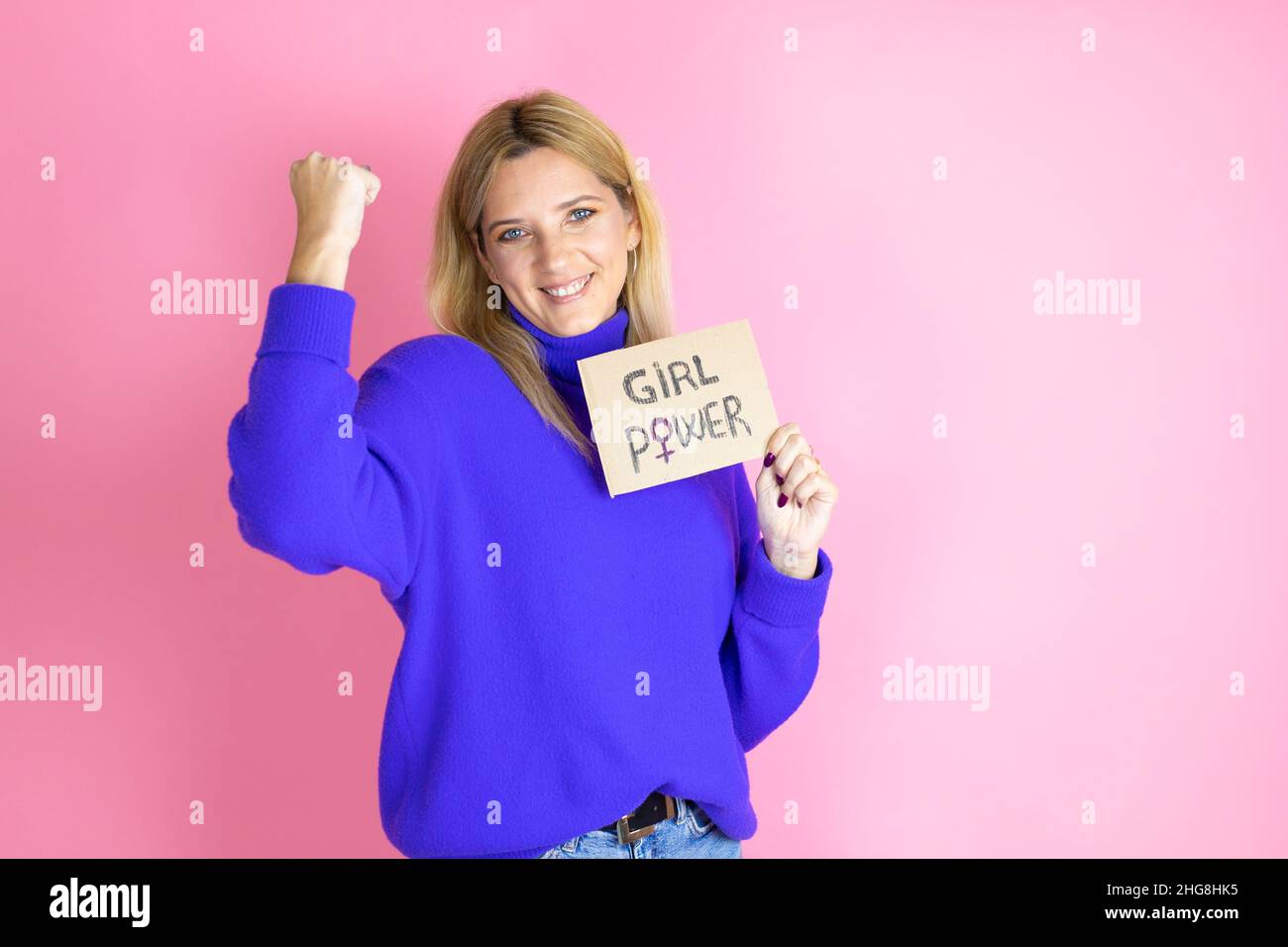 Young beautiful activist woman protesting holding poster with girl ...