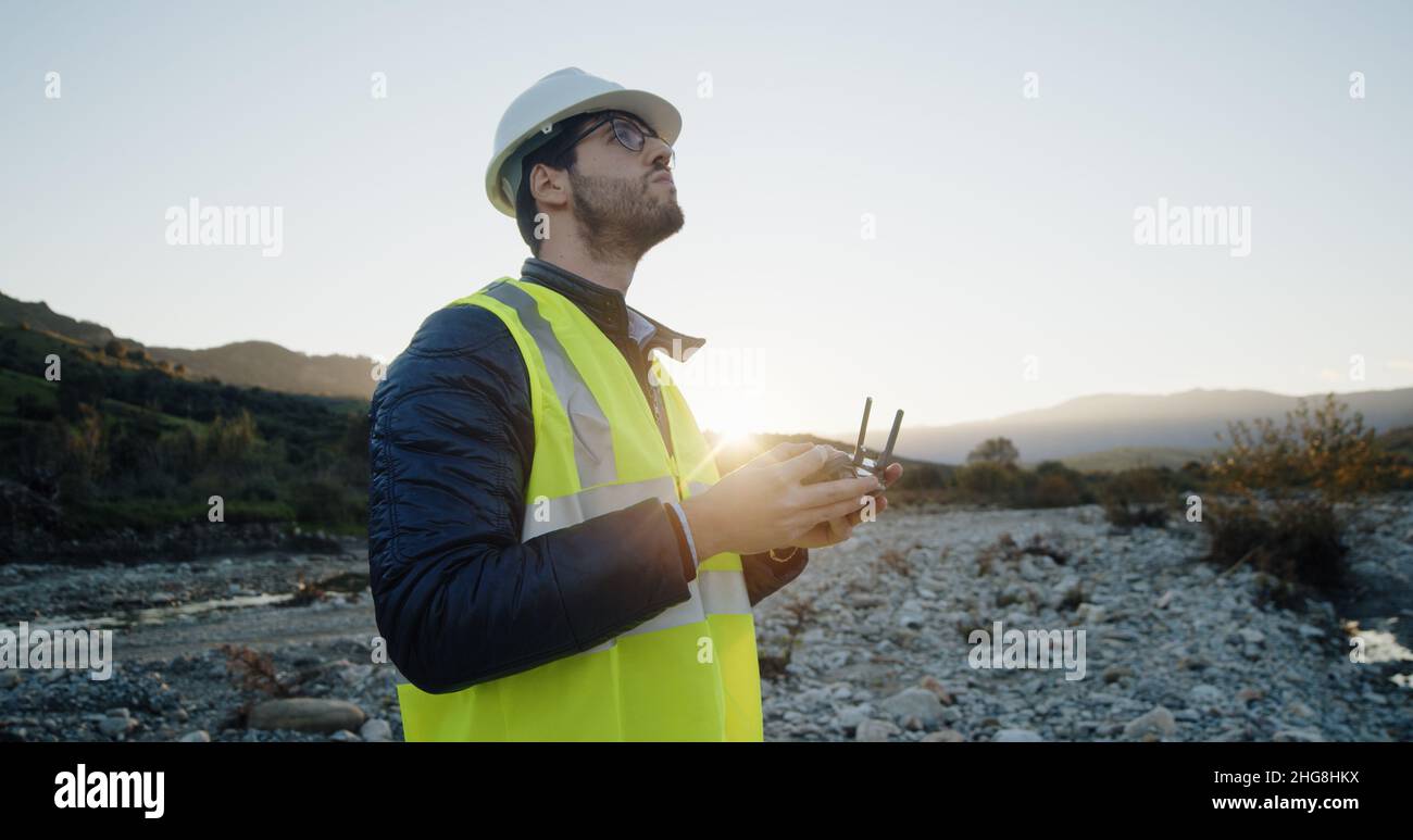 engineer with remote controller of drone checks the state of the ...