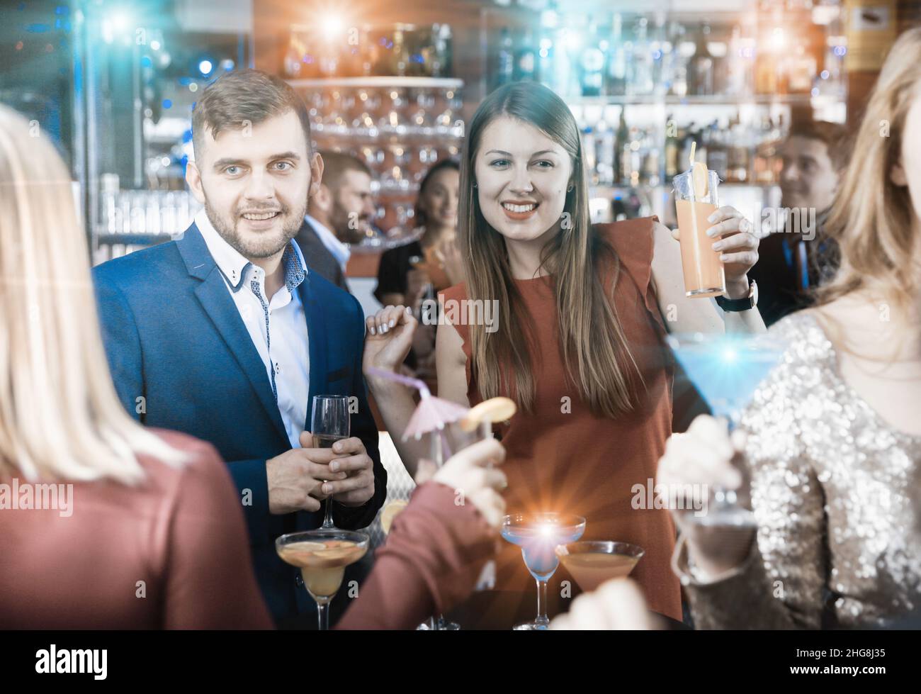 Woman with colleagues on corporate party in bar Stock Photo - Alamy