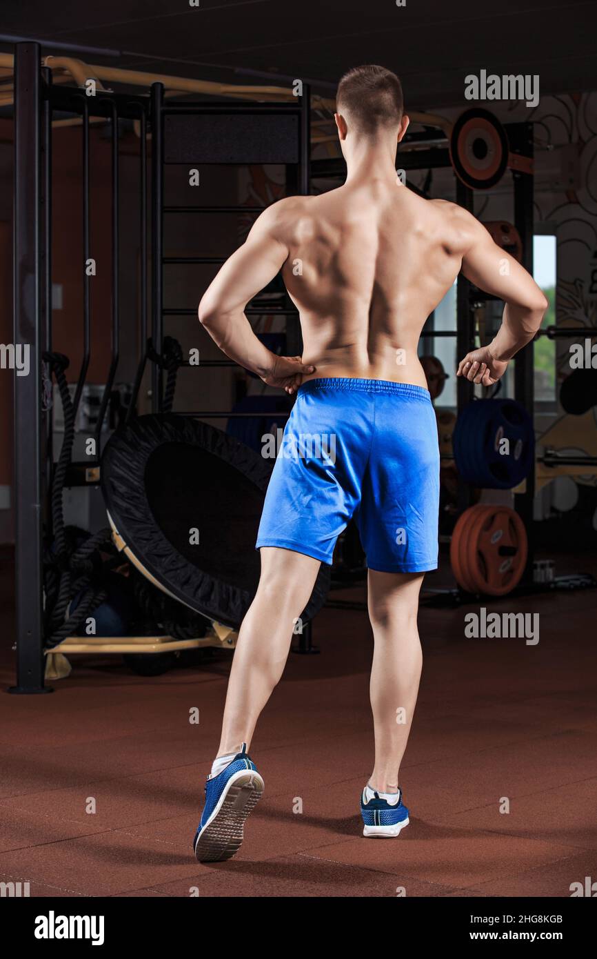Man standing strong in the gym and flexing muscles Stock Photo - Alamy