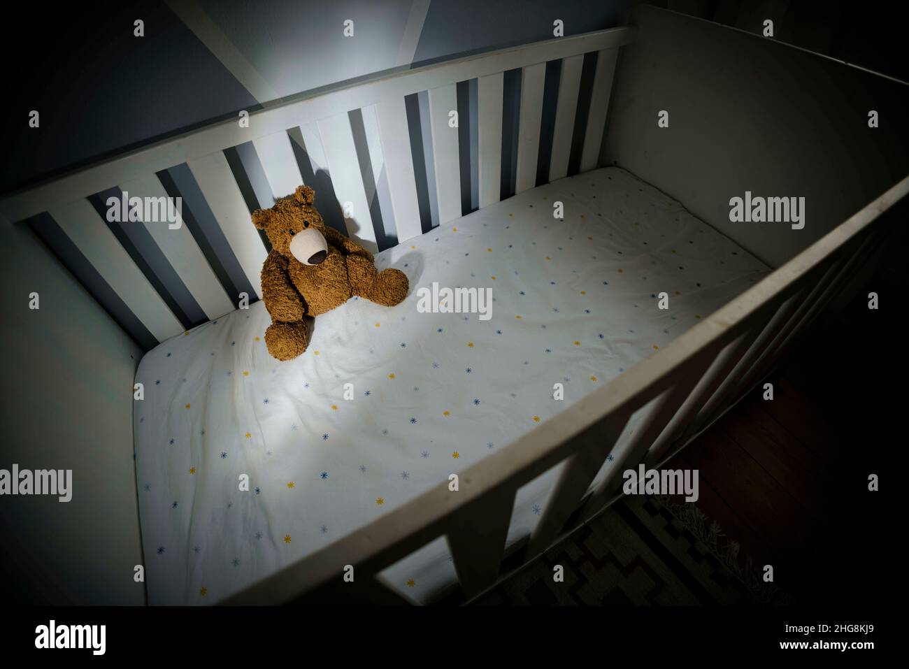 Symbolic photo on the subject of child abuse. A teddy bear sits in an ...