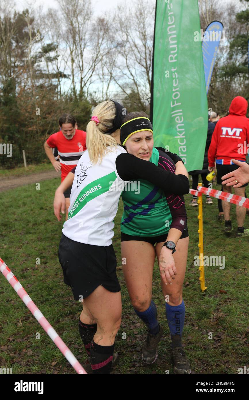 runner supporting rival at end of a running race Stock Photo - Alamy