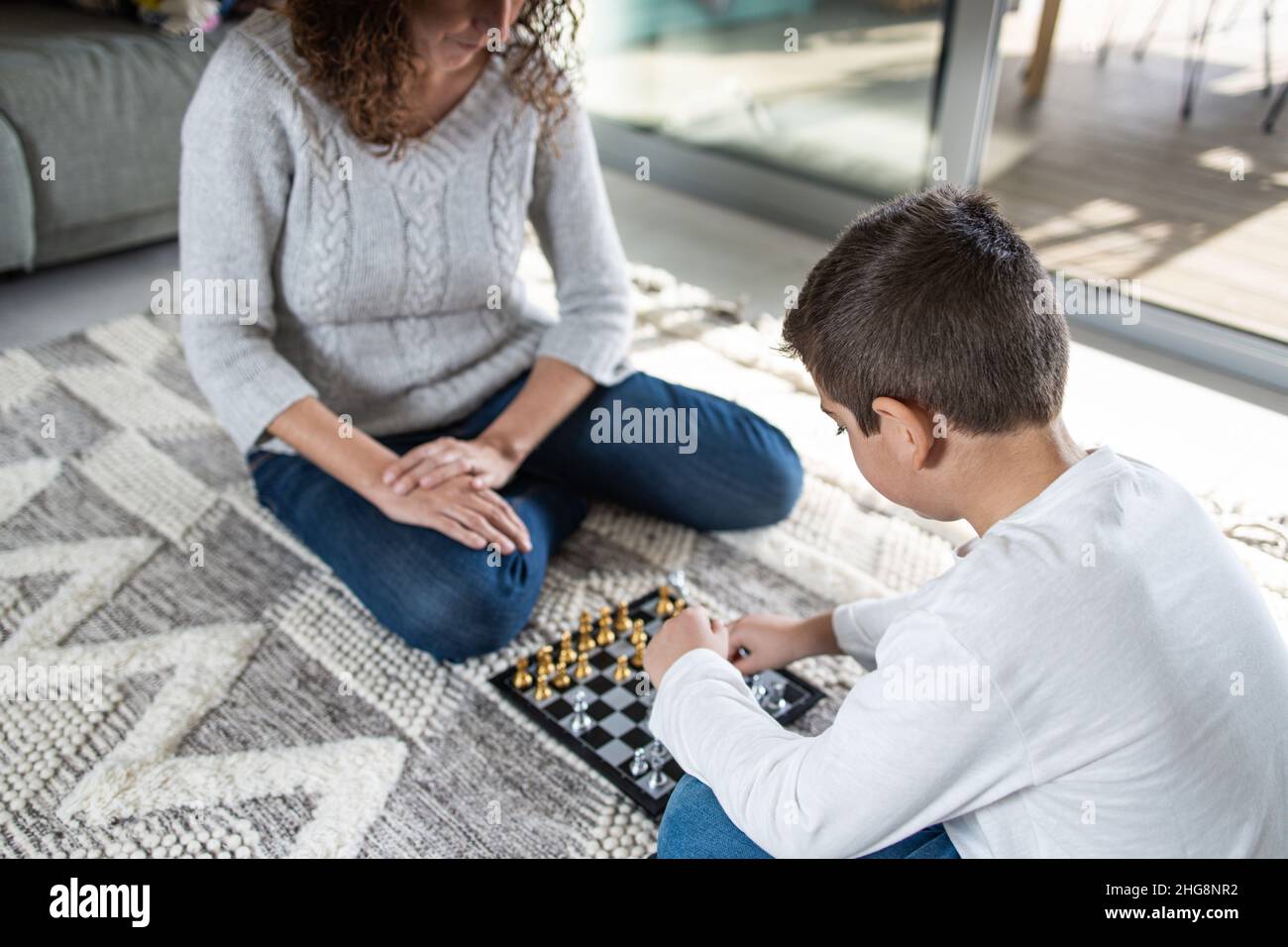 Mother and son playing chess at home Stock Photo - Alamy