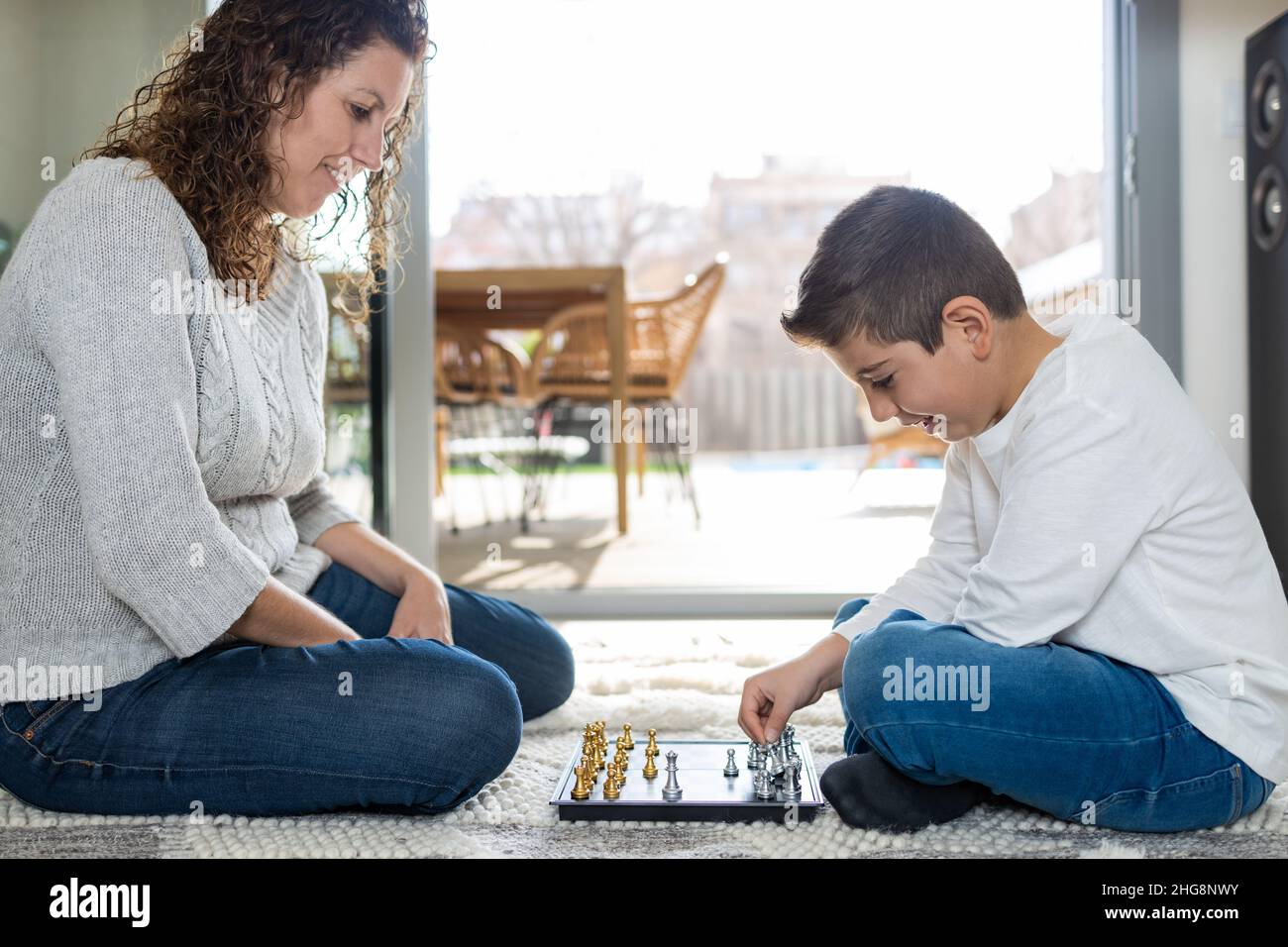 Mother and son playing chess at home Stock Photo - Alamy