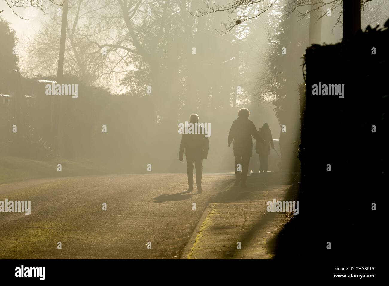 People walking in winter fog, Snitterfield village, Warwickshire ...