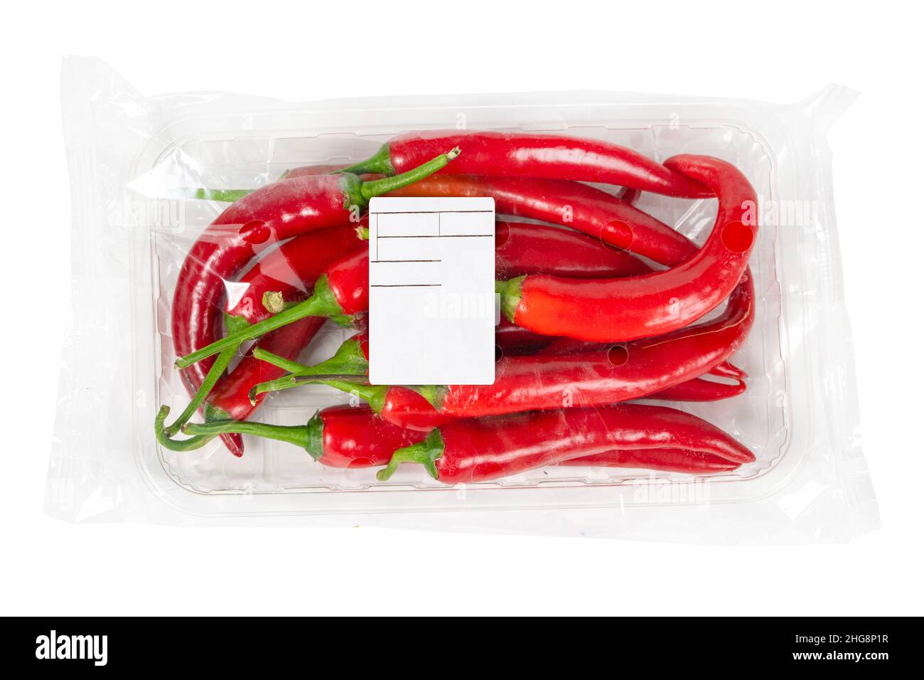 Packaged and labeled red chili peppers on an isolated white background ...