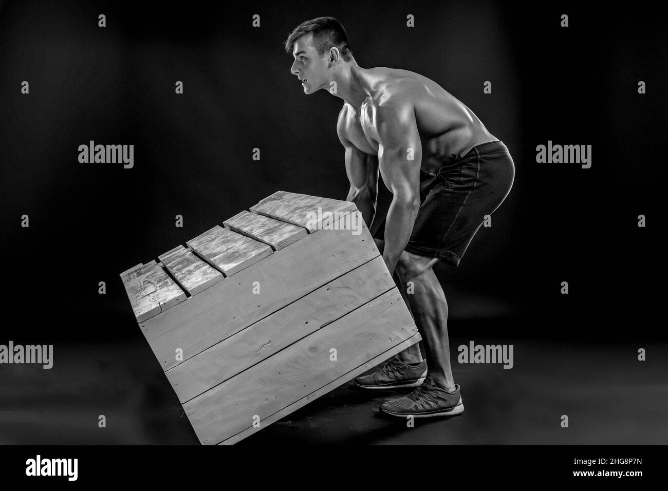 Young Muscular man flipping box Stock Photo - Alamy
