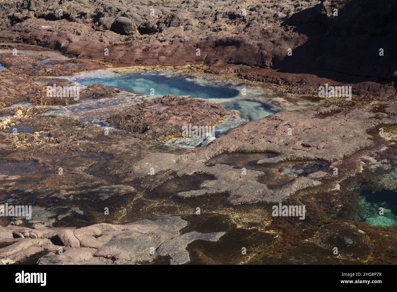 Gran Canaria, calm natural seawater pools under the steep cliffs of the ...