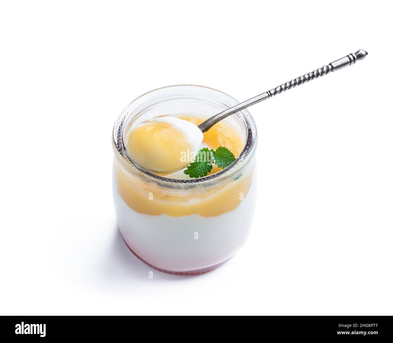 White creamy yogurt with yellow fruitty puree in small jar isolated on ...