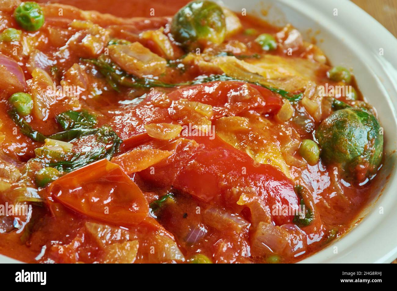 Coq au vin - French dish of chicken braised with wine, lardons ...