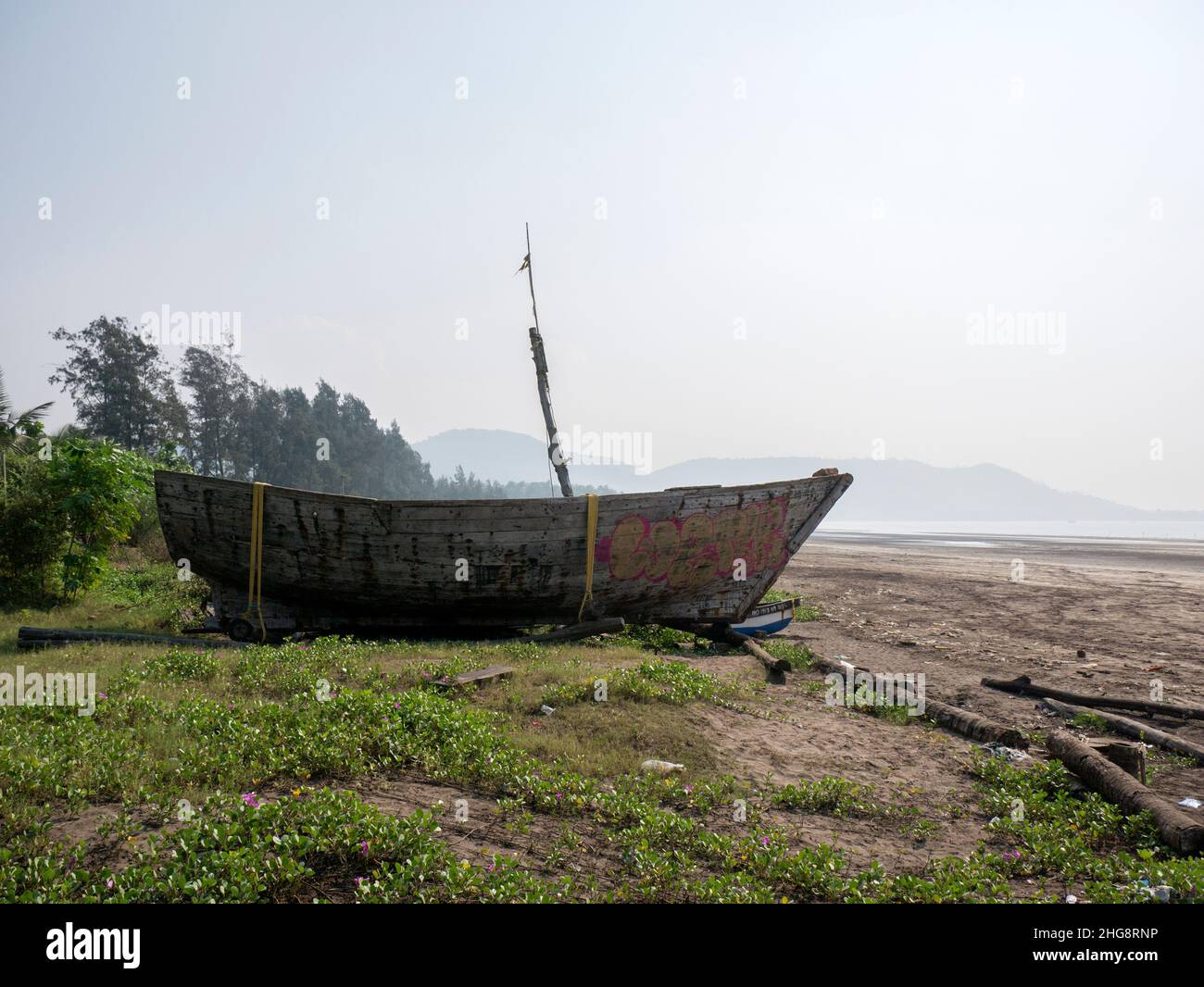 Native wooden fishing boat anchored at coastline at Revdanda near ...