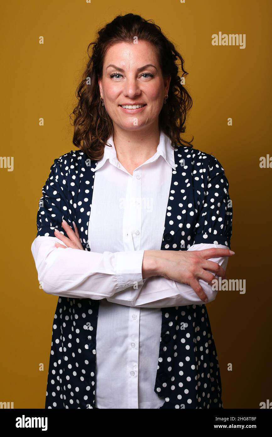 Portrait of a beautiful happy woman in front of a colored background ...