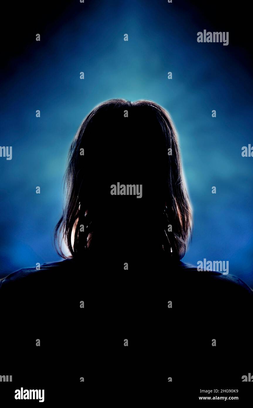 woman back head in silhouette against a blue background with backlight ...