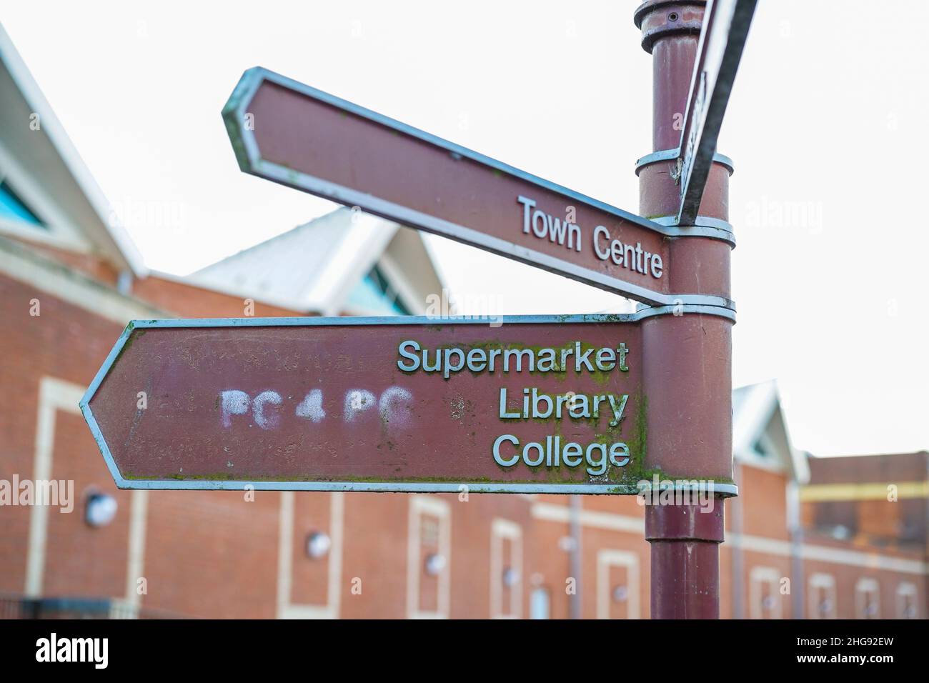 Town centre, supermarket,library and college signpost, UK Stock Photo ...