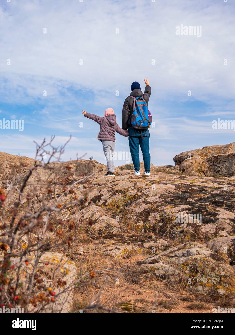 Travelers father daughter with raised hands walking climbing on ...