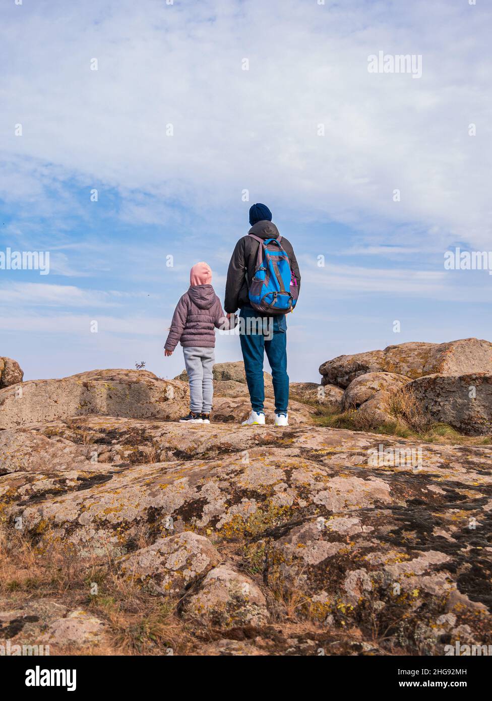 Travelers father and daughter walking climbing on mountain summit ...