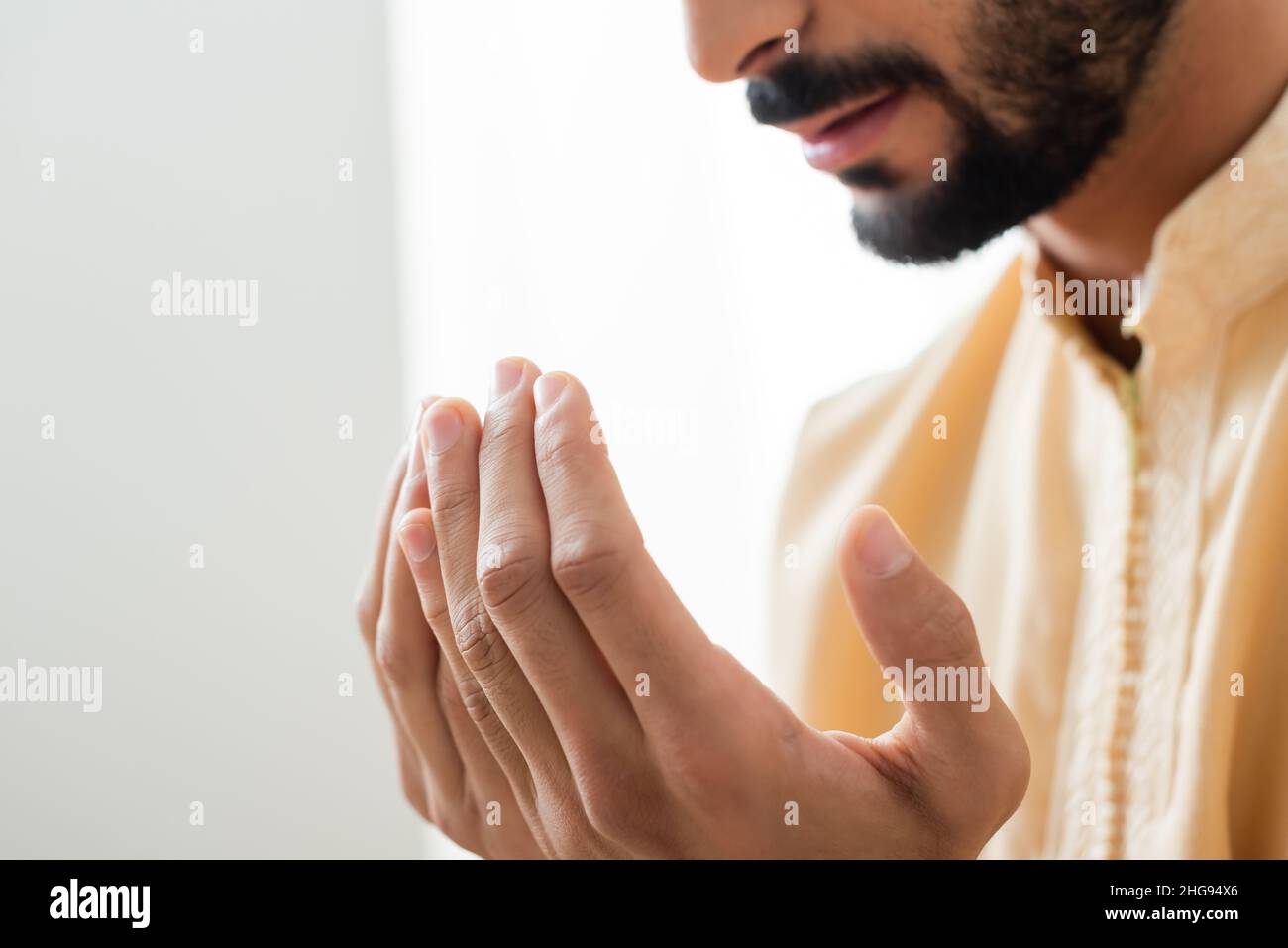 Cropped view of hands of blurred arabian man praying at home Stock Photo - Alamy