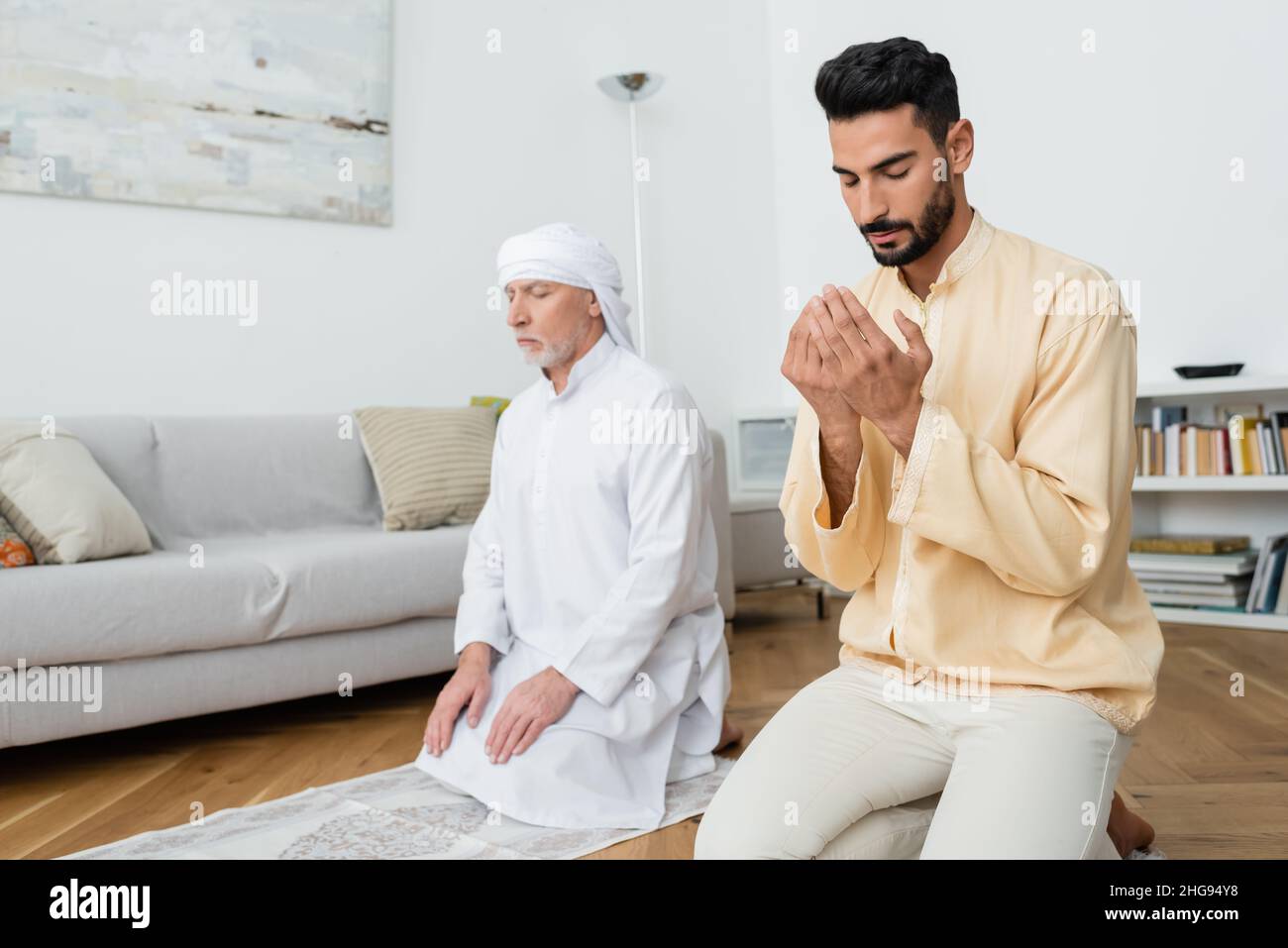 Middle aged father and arabian son praying at home Stock Photo - Alamy