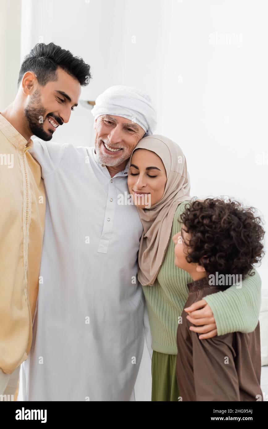 cheerful multiethnic muslim family embracing at home Stock Photo - Alamy