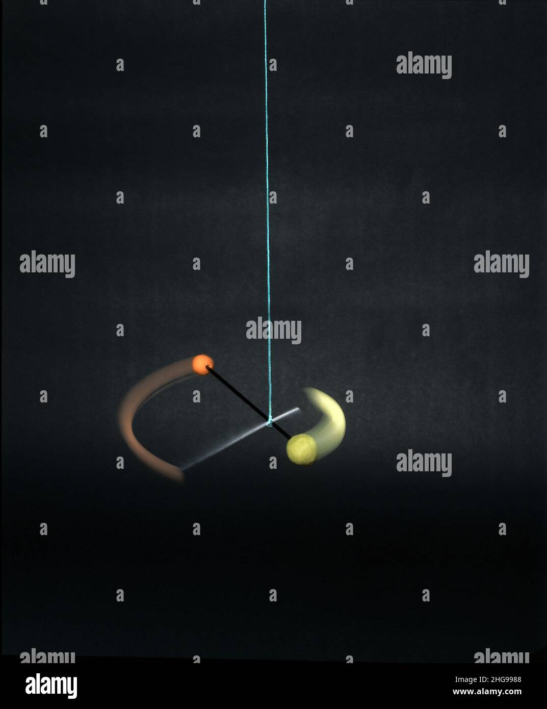 Spheres rotating around string Stock Photo - Alamy