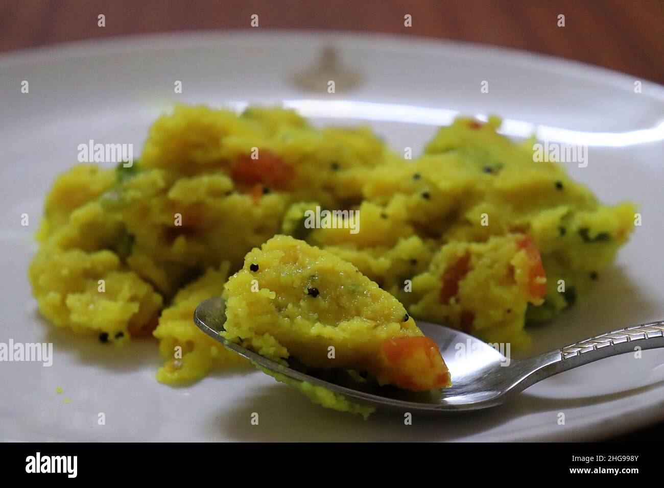 South Indian/vegetable Semolina/Rava Upma in a ceramic plate/Breakfast ...