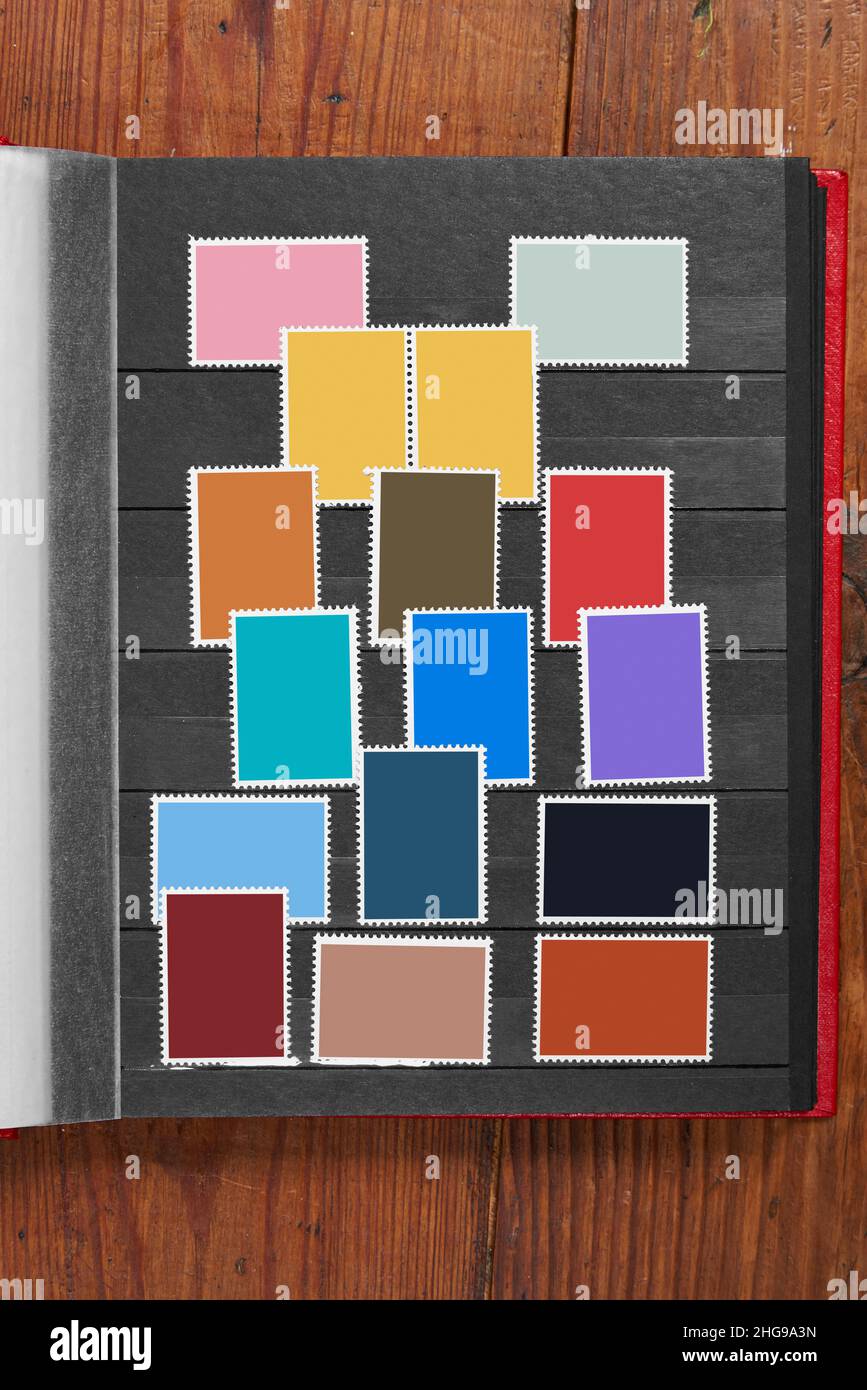 Postage stamps frames set in vintage album on wooden table Stock Photo ...