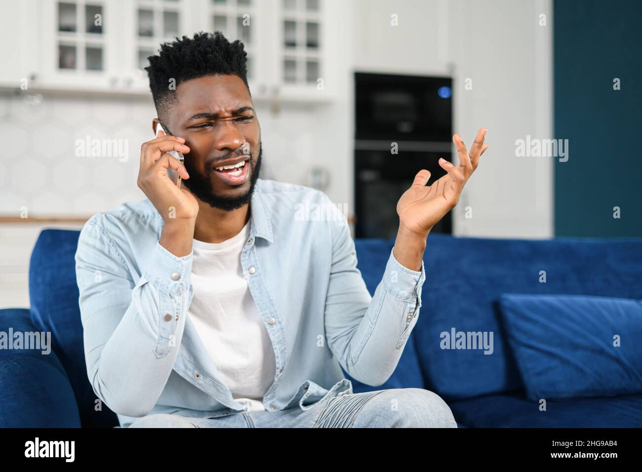 Angry stressed multiracial man having unpleasant phone conversation ...