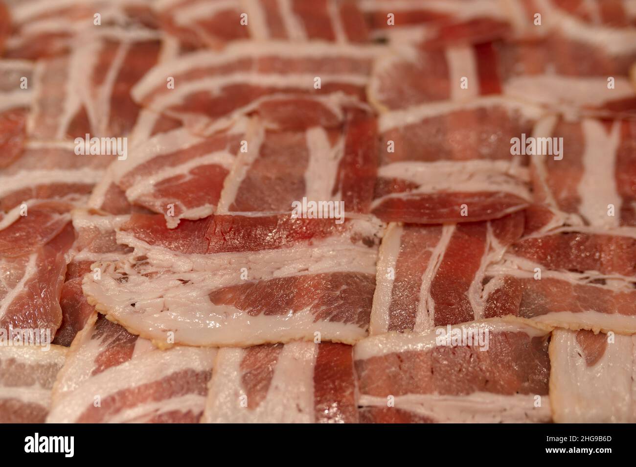 Bacon. Cut the bacon into strips Stock Photo - Alamy