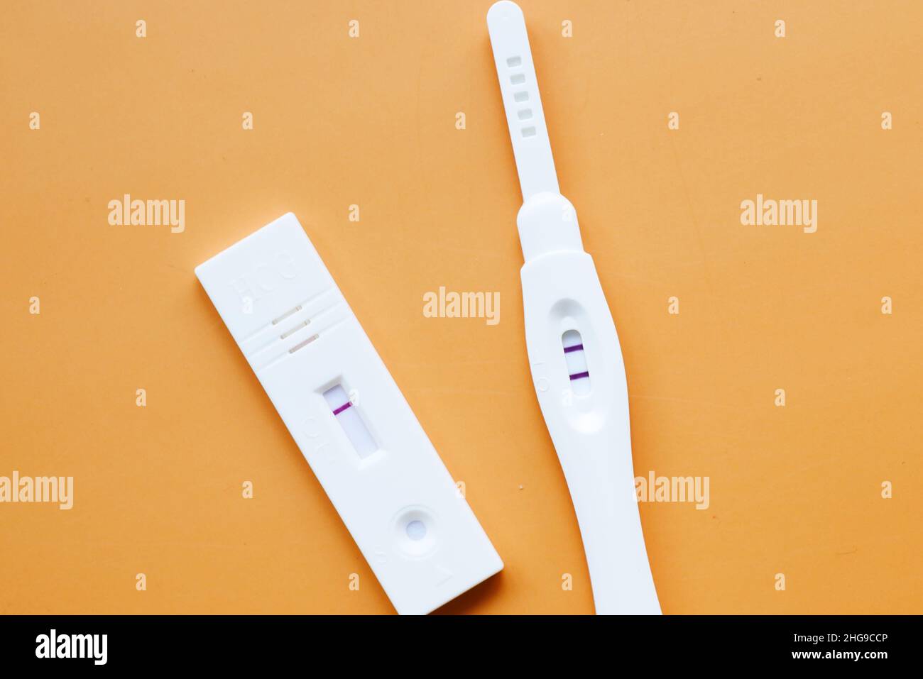Pregnancy test kit on orange background Stock Photo - Alamy