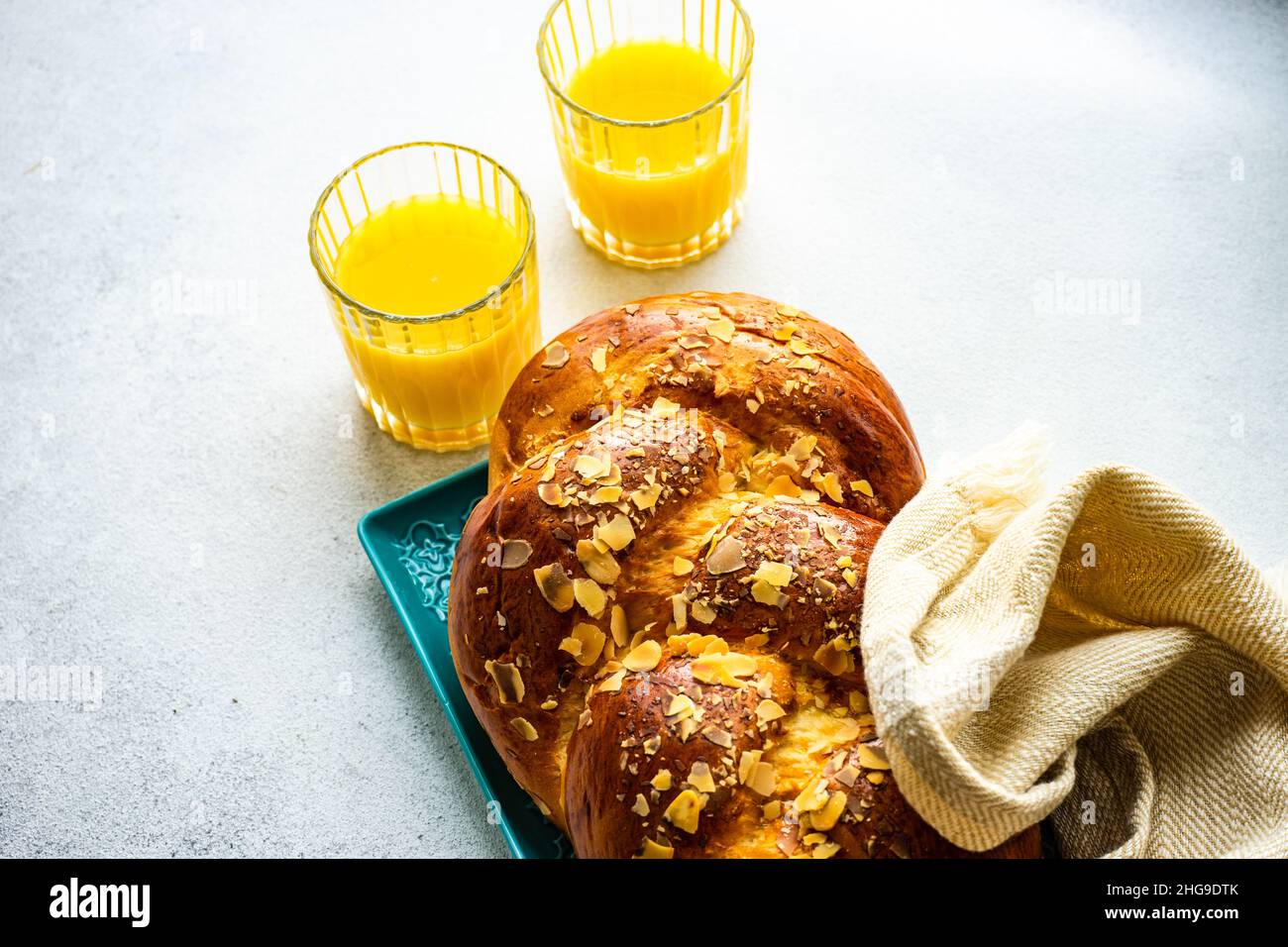Overhead view of a traditional tsoureki Easter loaf with almonds with ...