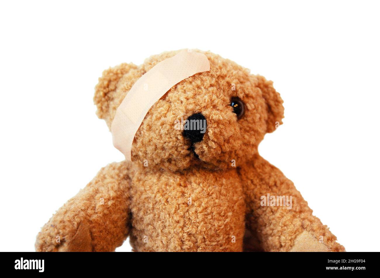 Teddy with a plaster on his eye Stock Photo - Alamy