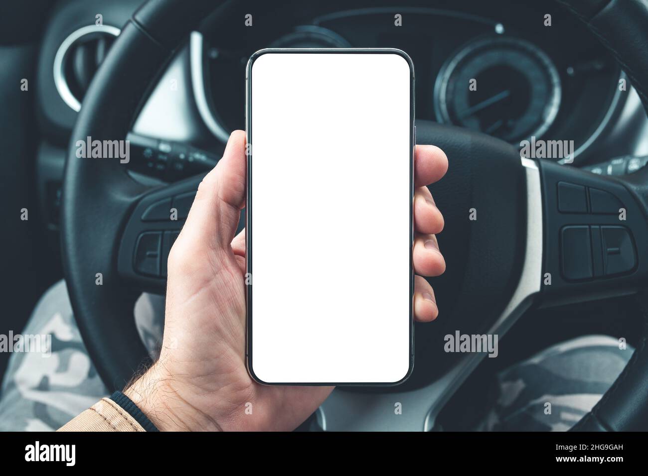 Smartphone mockup in male driver hand over car steering wheel ...