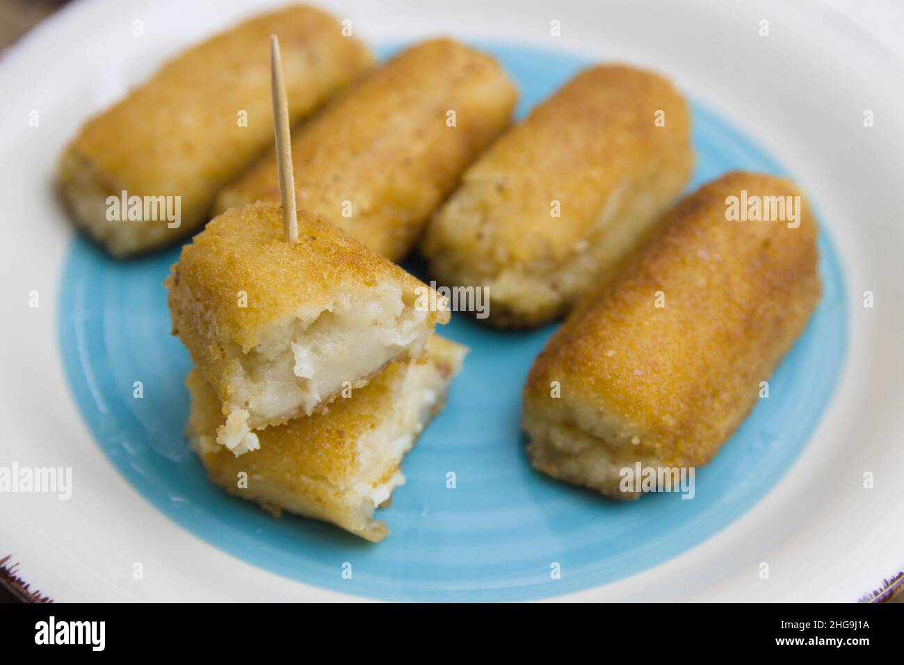 Plate with industrially prepared croquettes on a plate with a blue ...