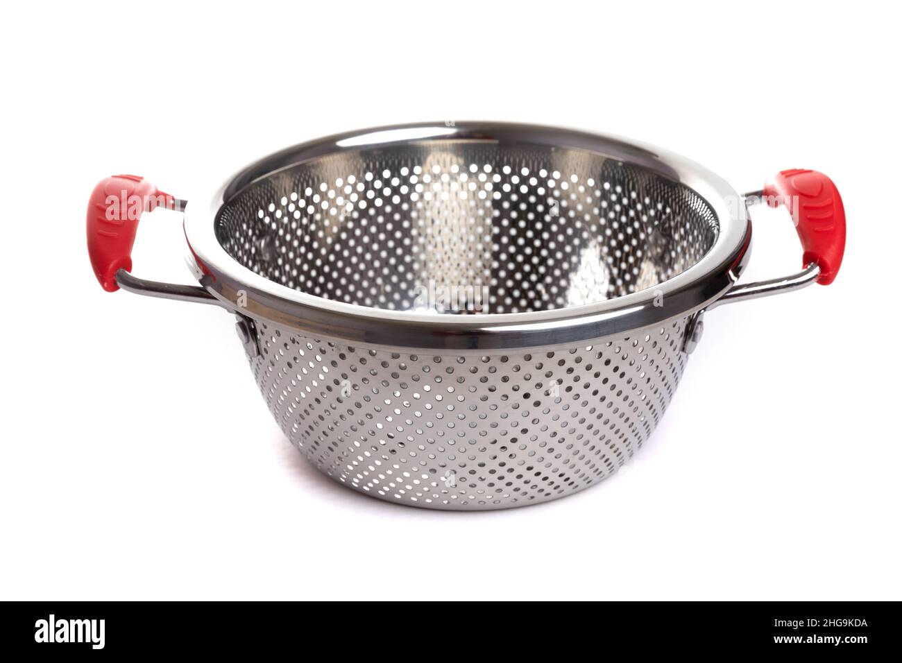 metal chrome colander with red handles on a white isolated background ...