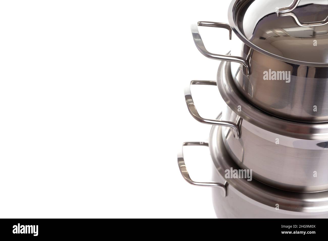 a stack of 3 metal pans with a glass lid on a white background Stock ...