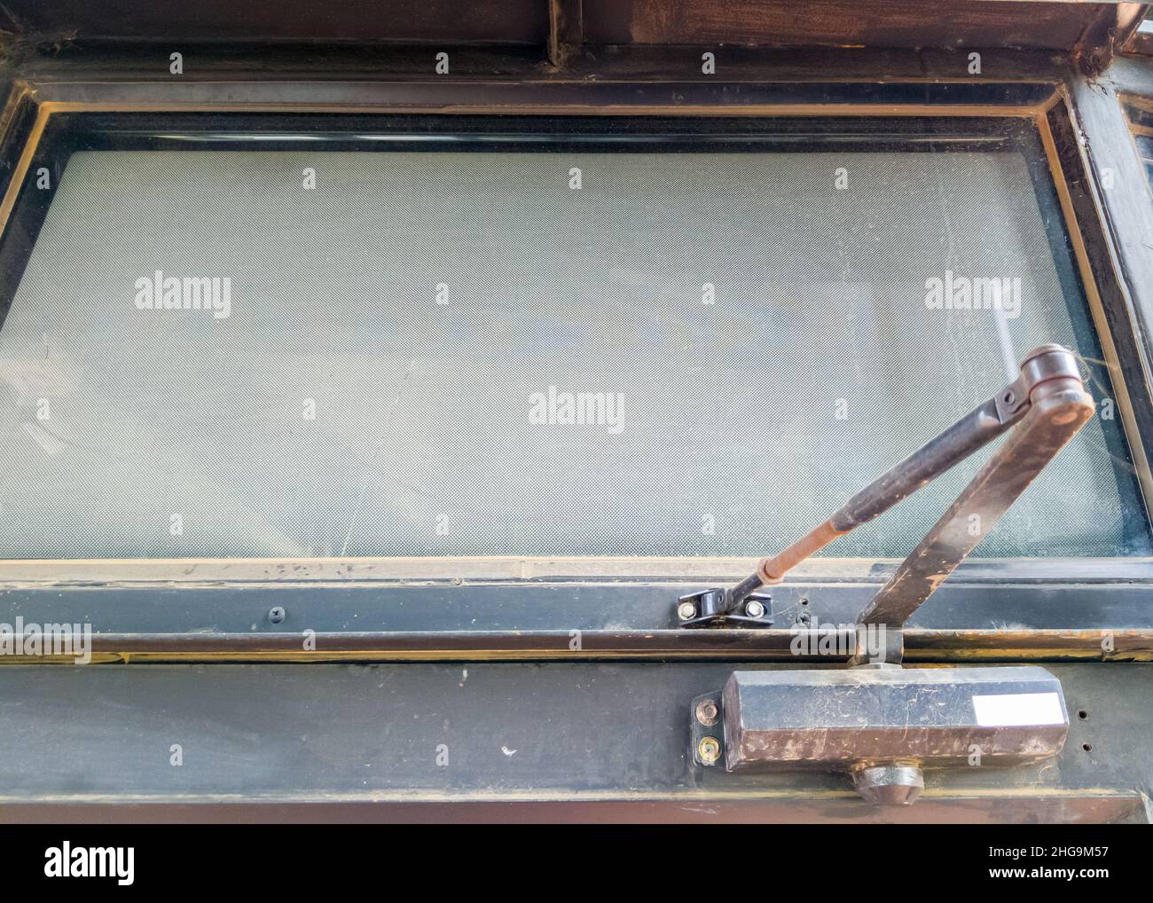 Closeup of the dirty door closers with the rust stain for open to the ...