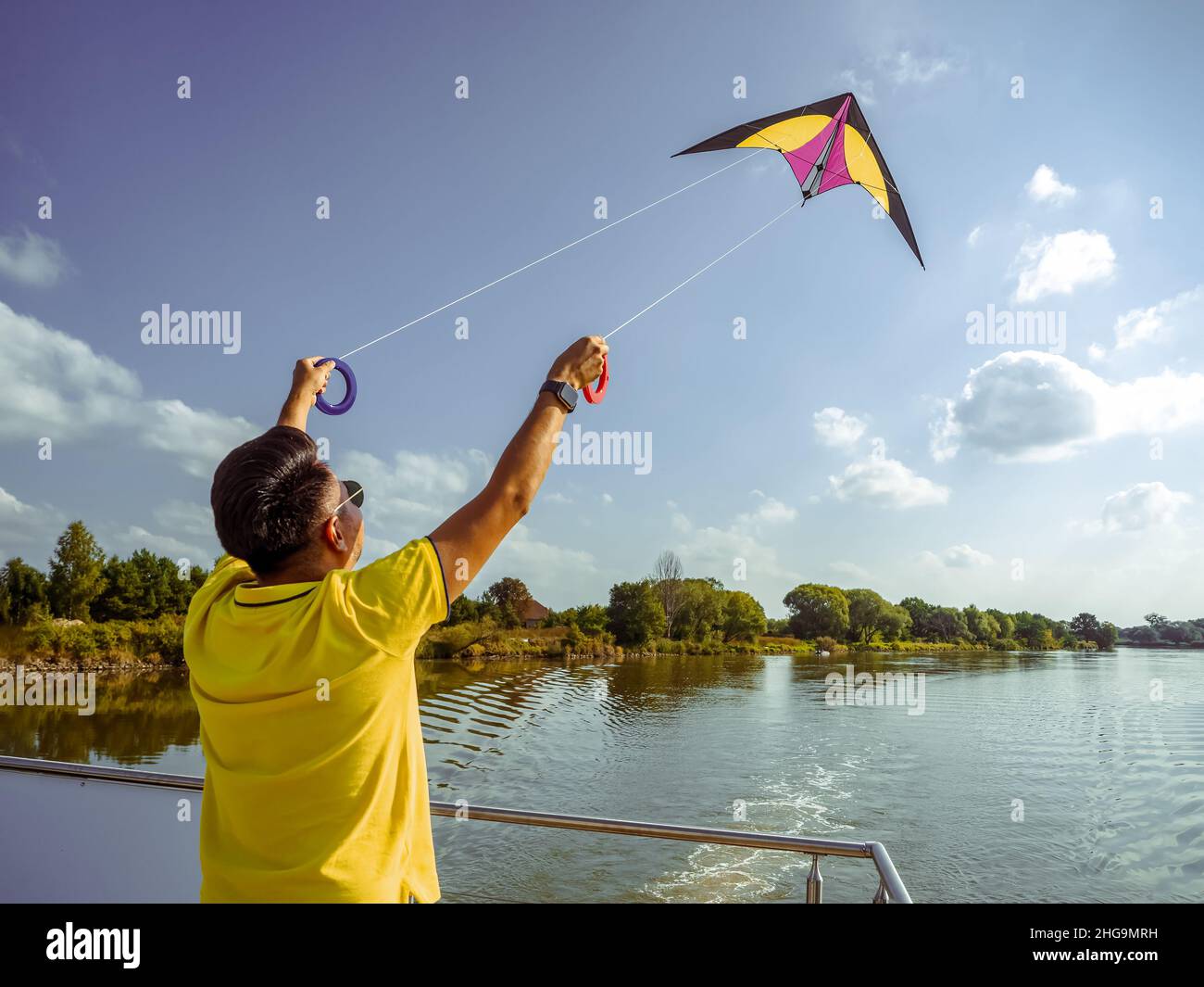 young man is standing on terrace of floating house and starting to fly ...