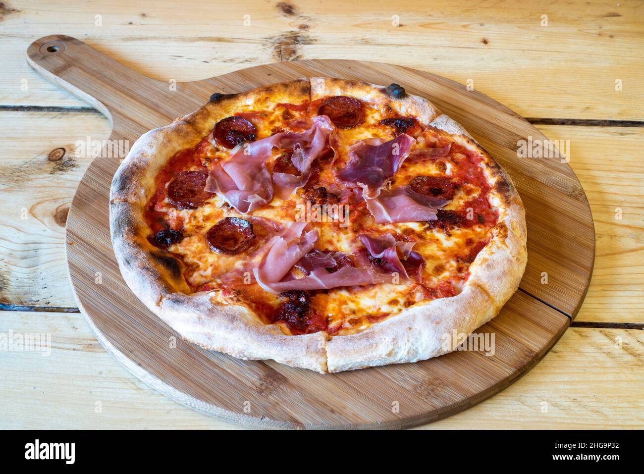 Delicious artisan wood-fired handmade meat feast pizza with pepperoni ...