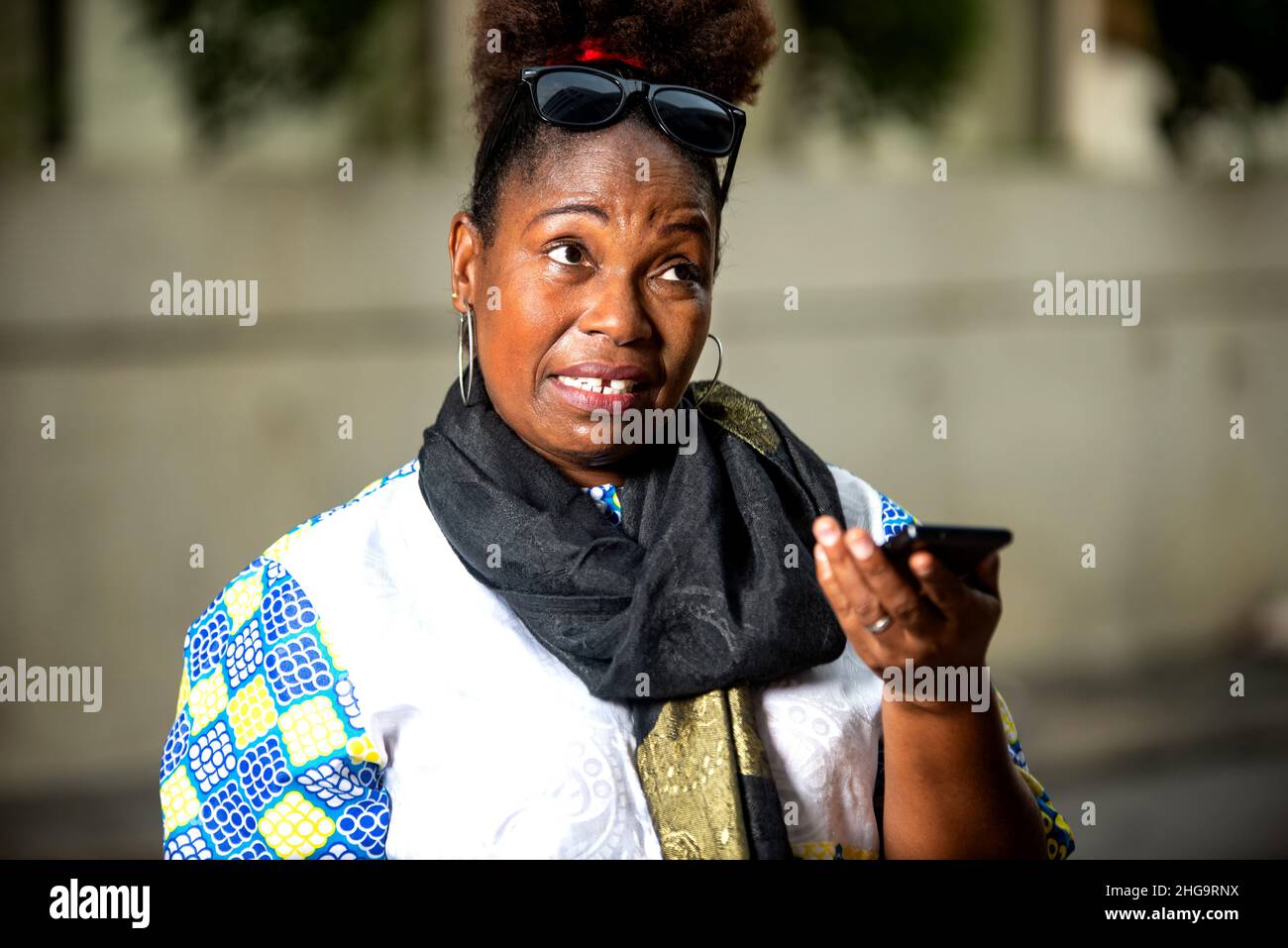 mature businesswoman with scarf wrapped around her neck holding a ...