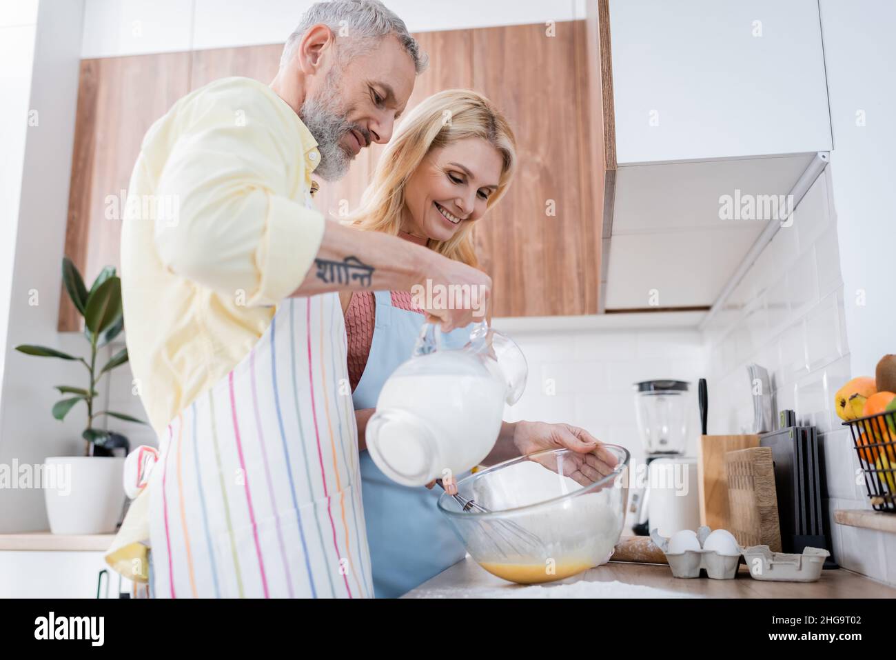 Blonde woman cooking husband hi-res stock photography and images - Alamy