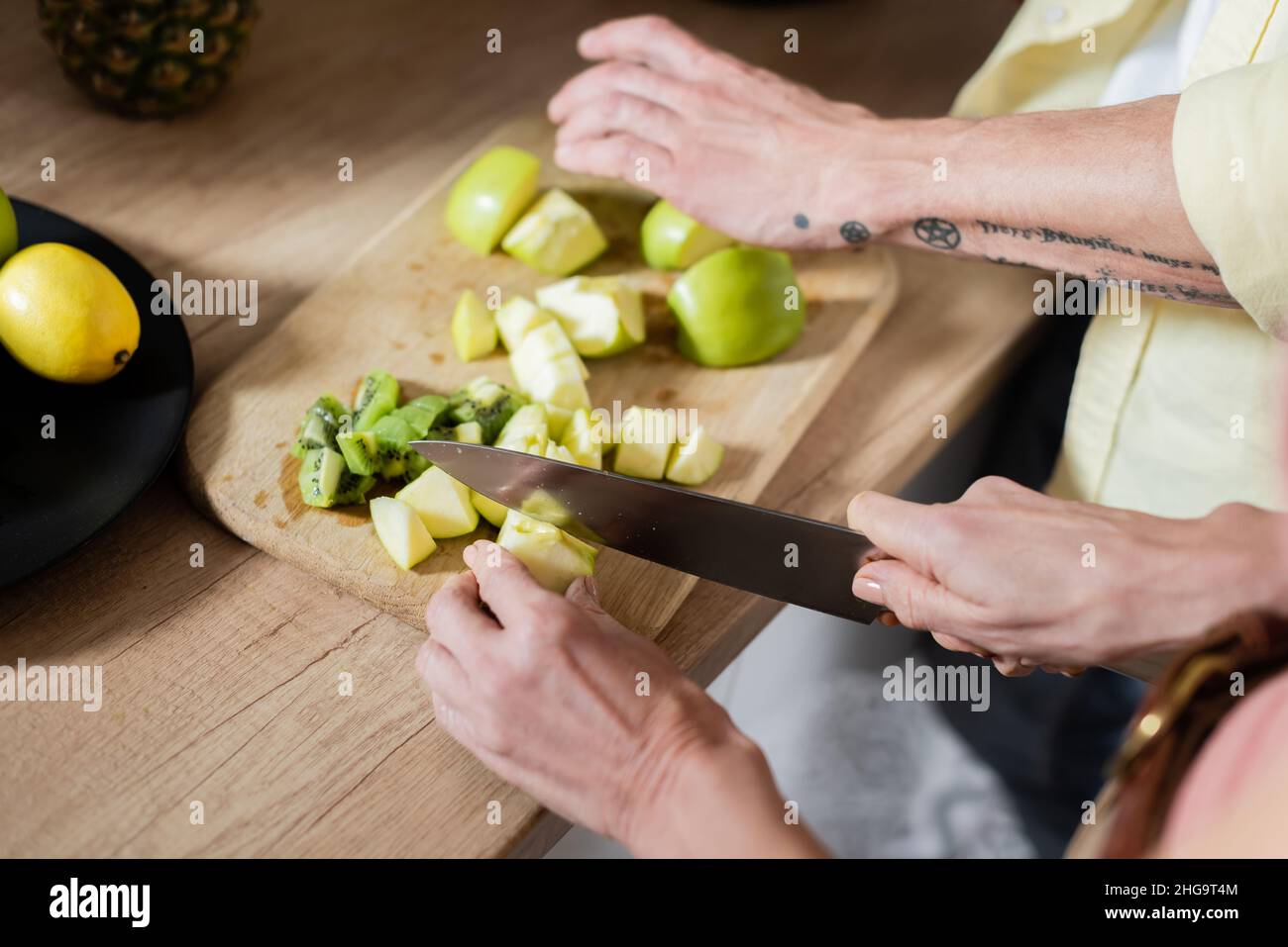Woman cut apple in kitchen hi-res stock photography and images - Alamy